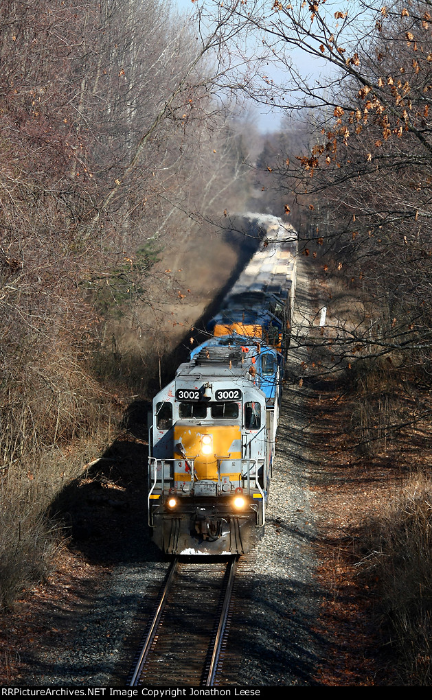 GLLX 3002 leads 103 cars crawling south through the shadows
